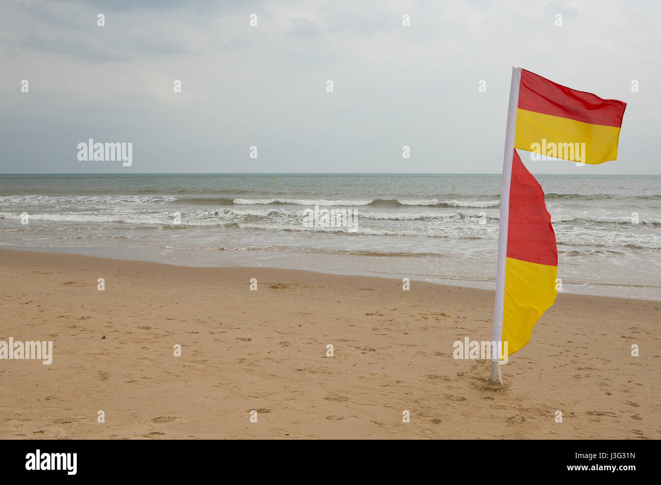RNLI Lifeguards red and yellow safety flags indicate the safe area for ...