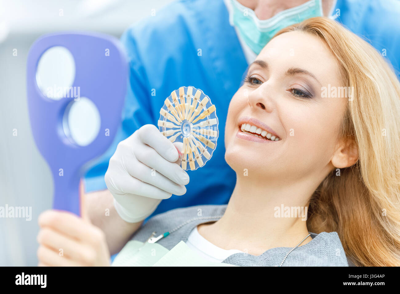 dentist matching teeth colour with palette in dental clinic Stock Photo ...