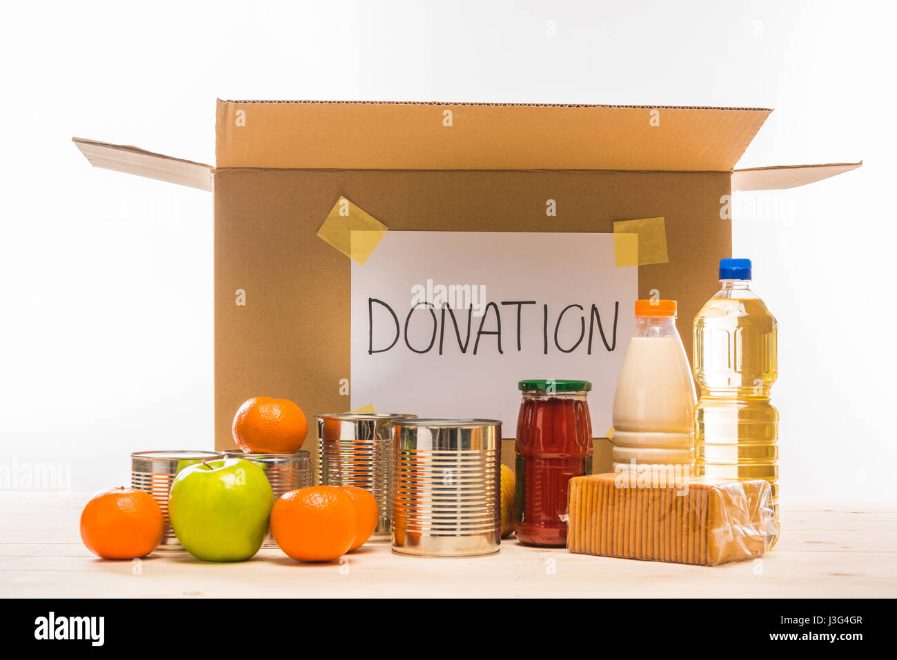 different food with cardboard box and donation sign on wooden table on ...