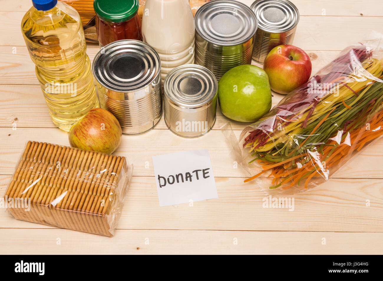 different food and paper note with word donation on wooden table ...