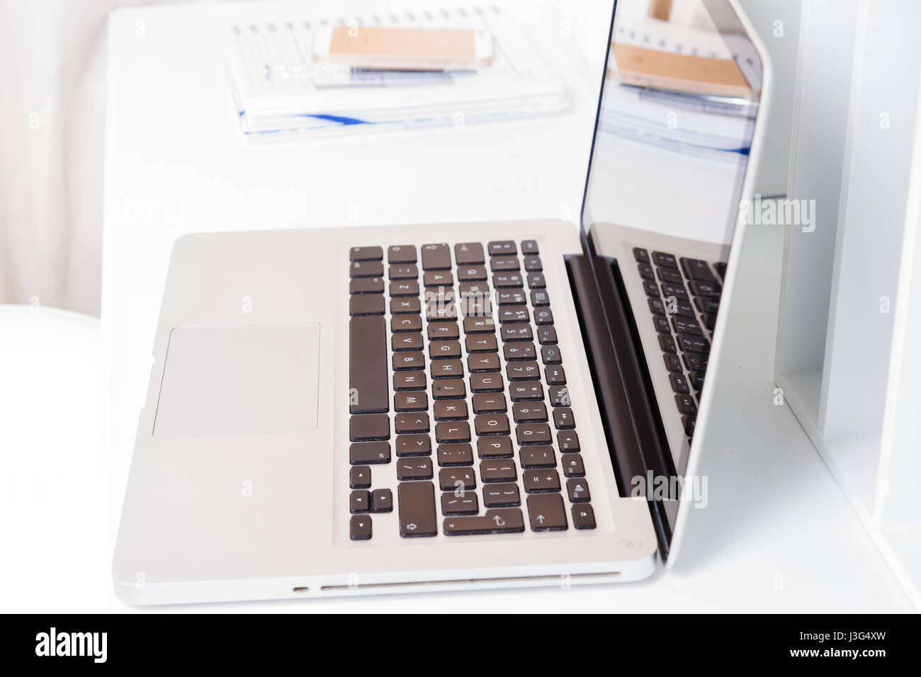 Open modern laptop on desk in light room Stock Photo - Alamy