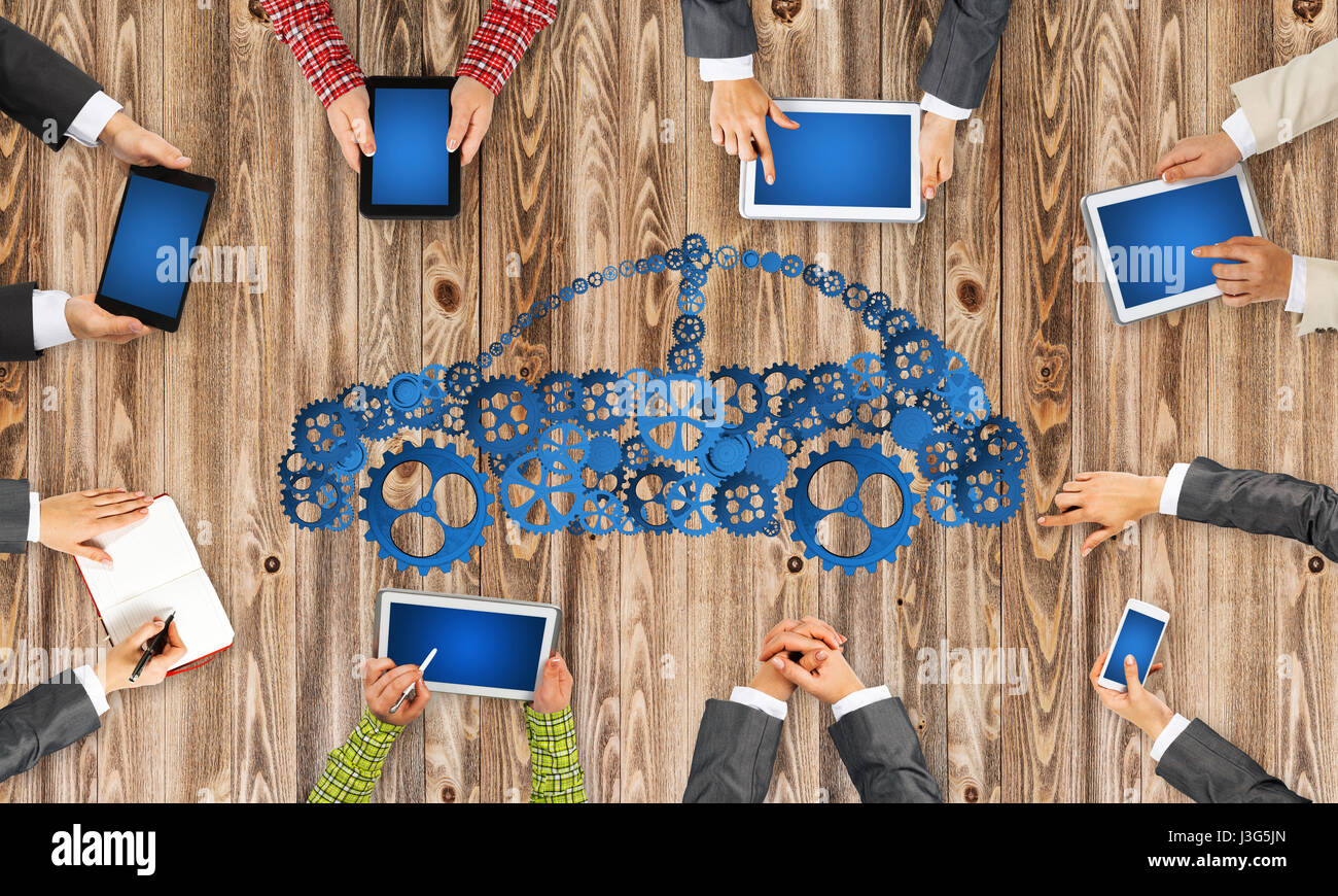Group of people with devices in hands working together as symbol of ...