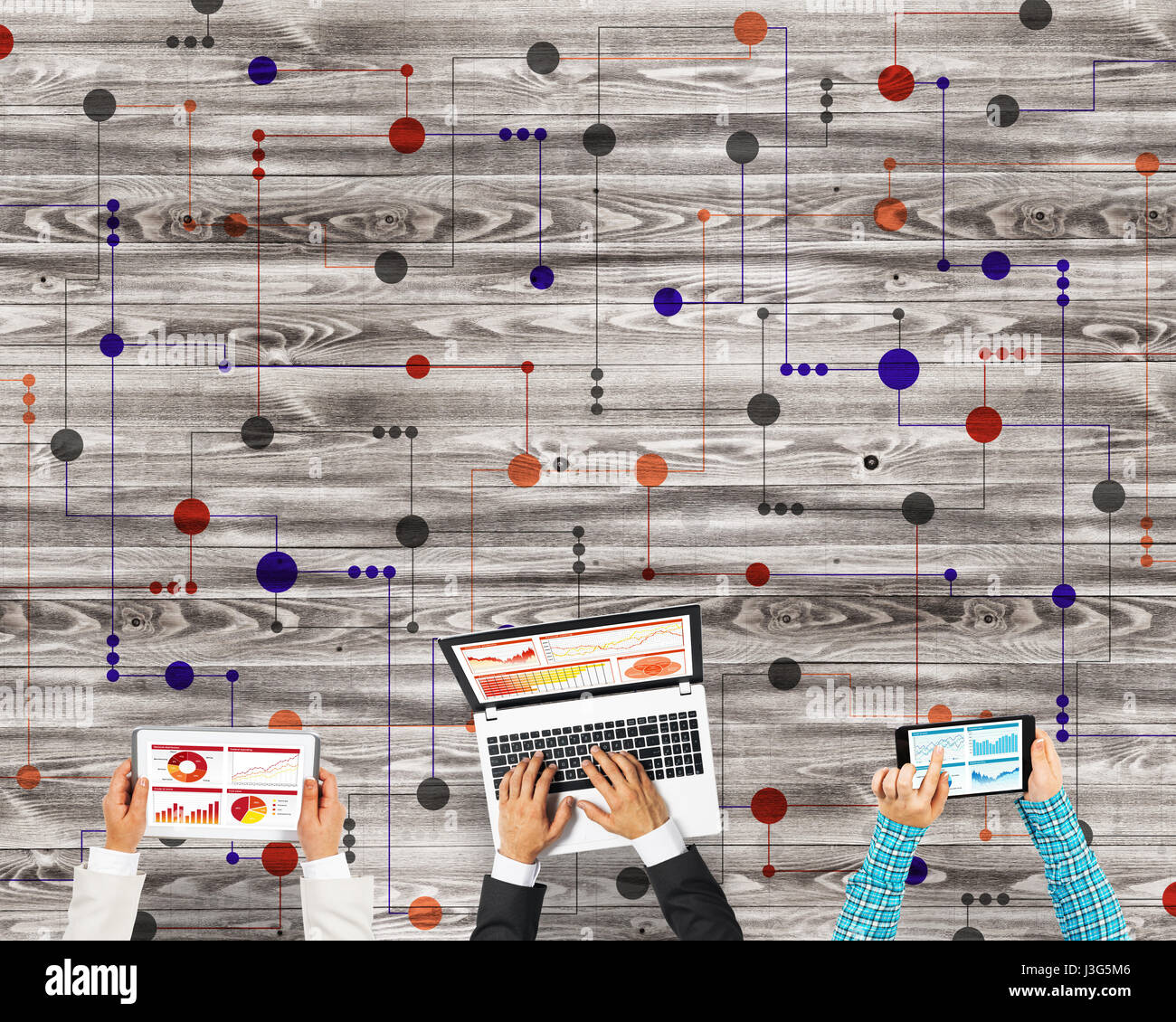Group of three people with devices in hands working together as symbol ...