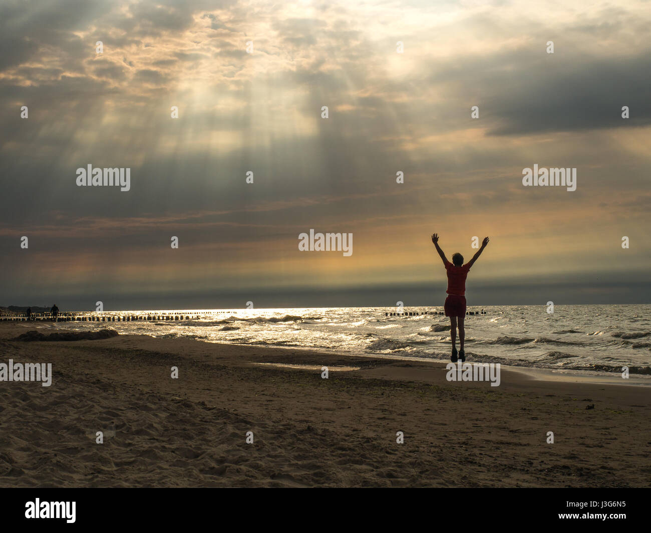 Happy boy on the beach at sunset time Stock Photo - Alamy
