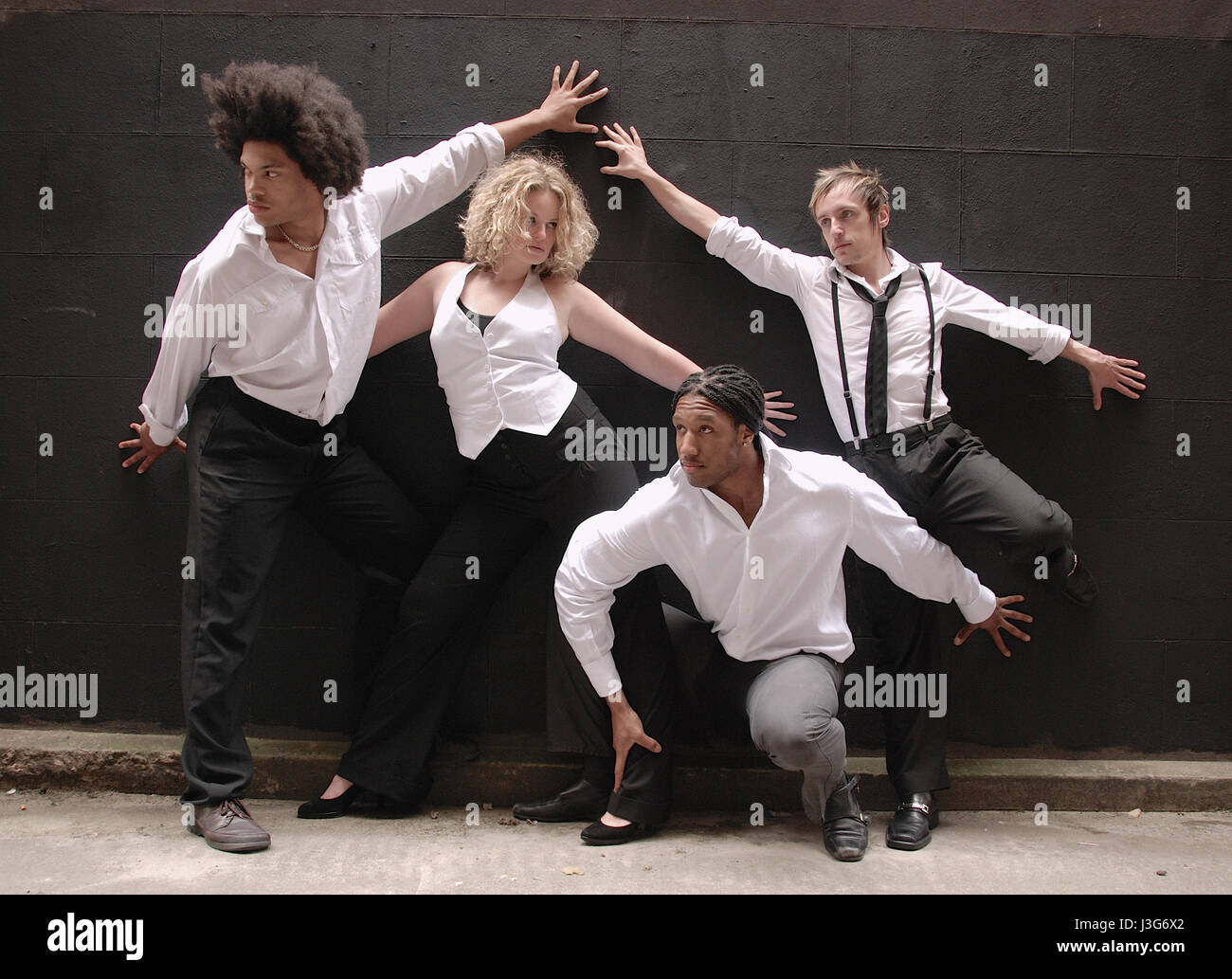 A group of young dancers in a city outdoor location wearing black and ...