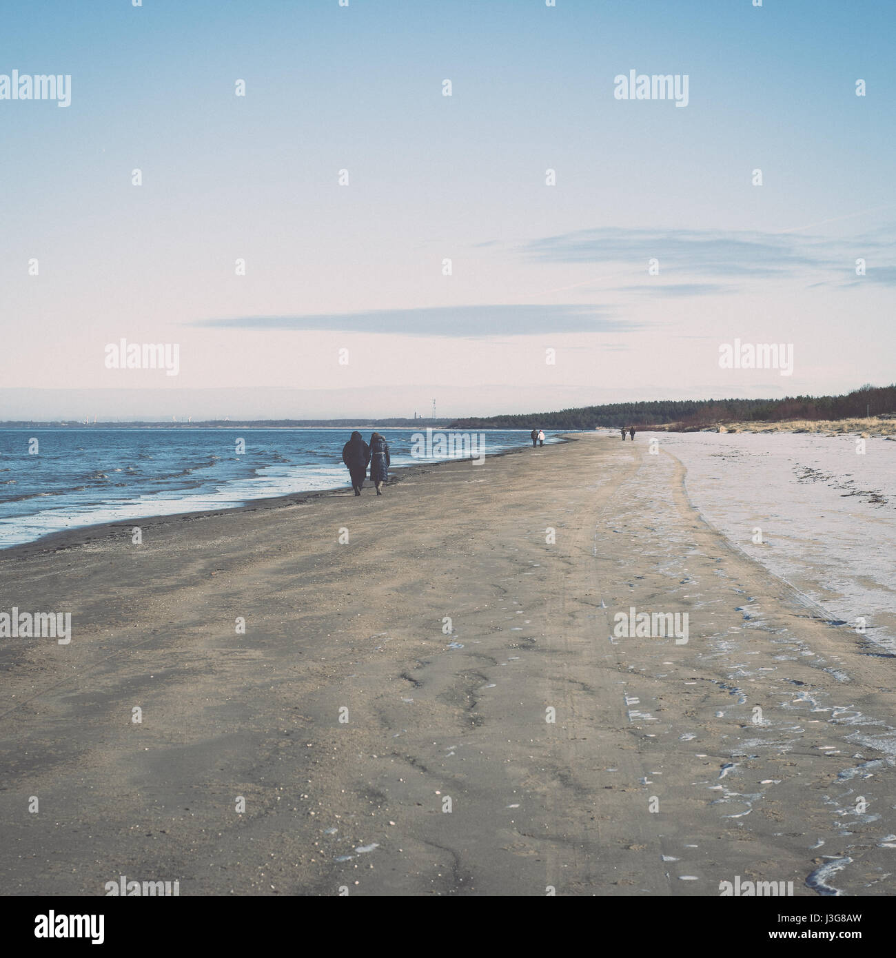 frozen sea beach with blue sky and snow covered tracks - retro vintage ...