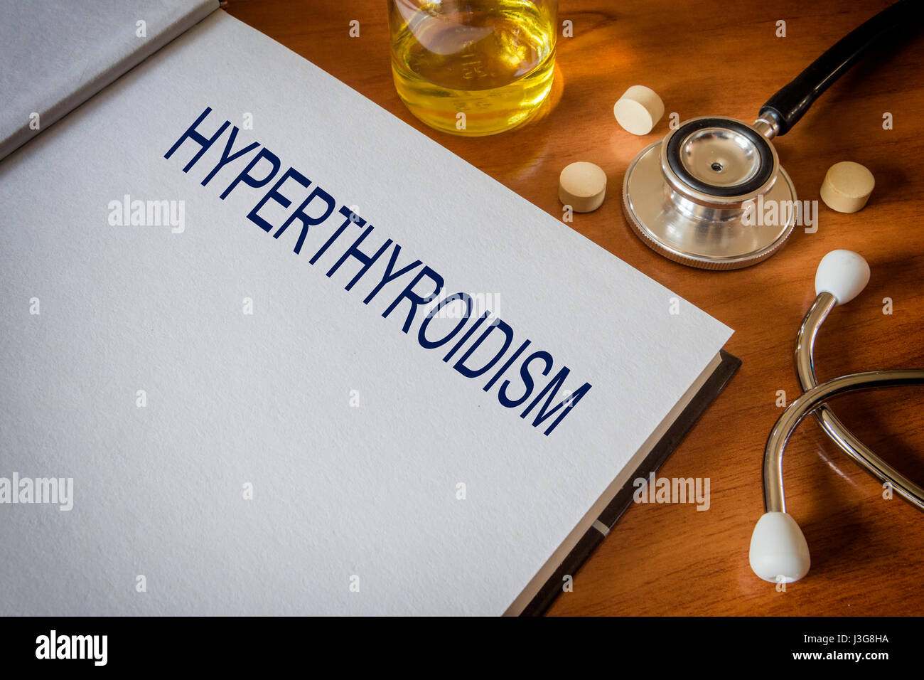 Hyperthyroidism written on book with tablets. Medicine concept Stock ...