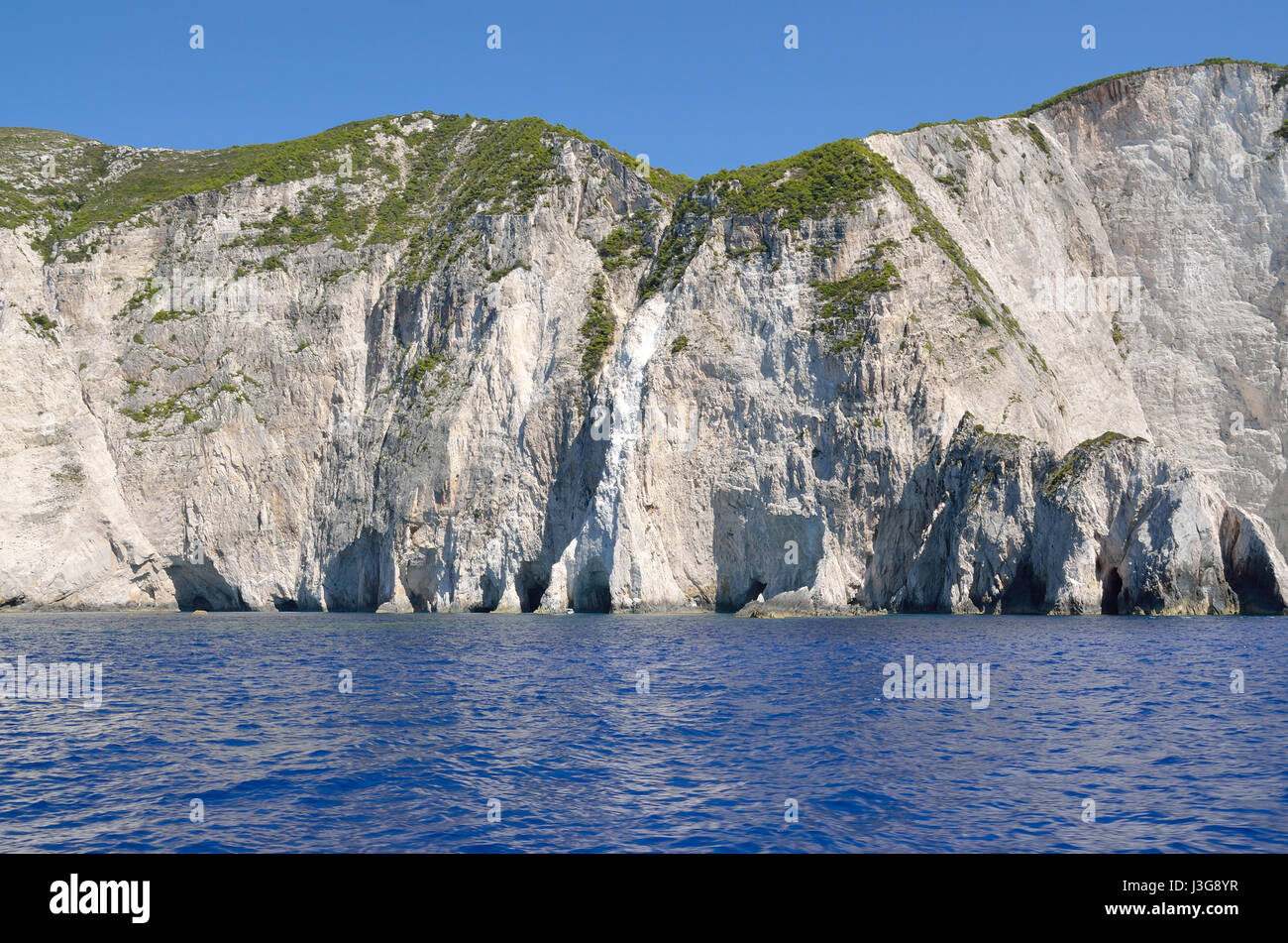 Coast cliff scenery with deep blue waters at Zakynthos coastline Stock ...