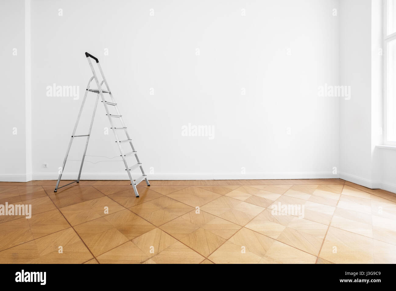 ladder in empty room with white wall and wooden floor Stock Photo - Alamy
