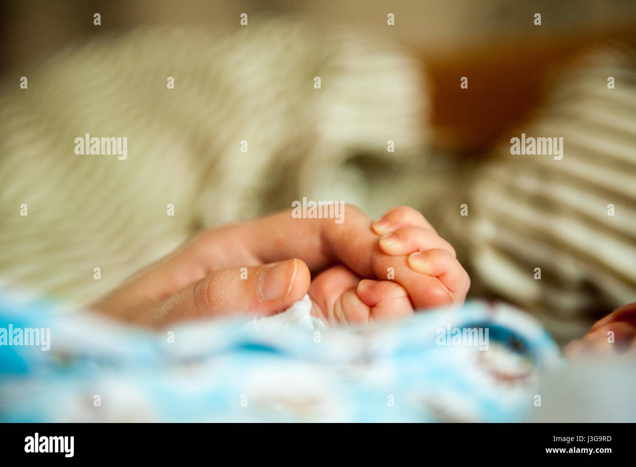 Hand the sleeping baby in the hand of mother close-up Stock Photo - Alamy
