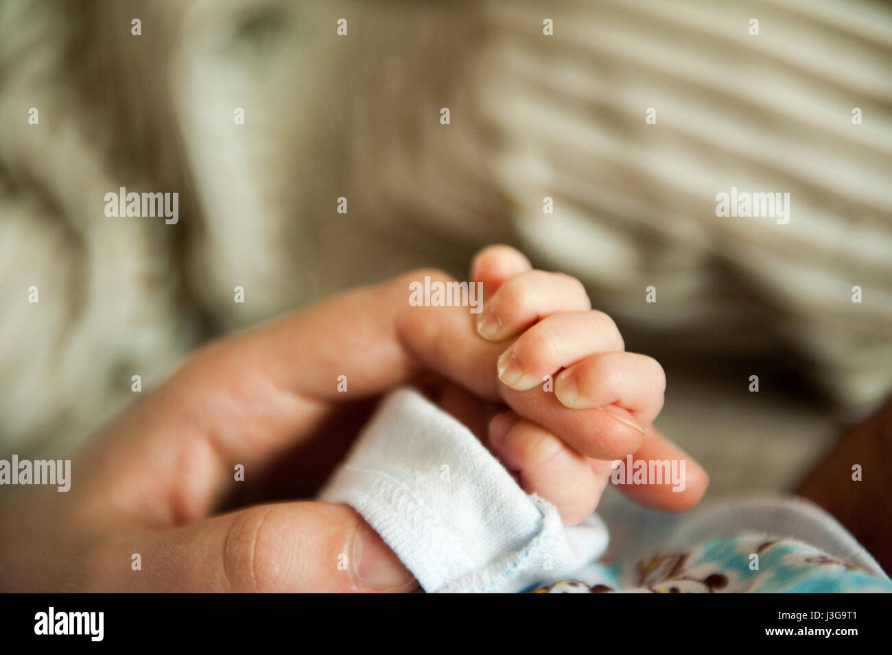 Hand the sleeping baby in the hand of mother close-up Stock Photo - Alamy