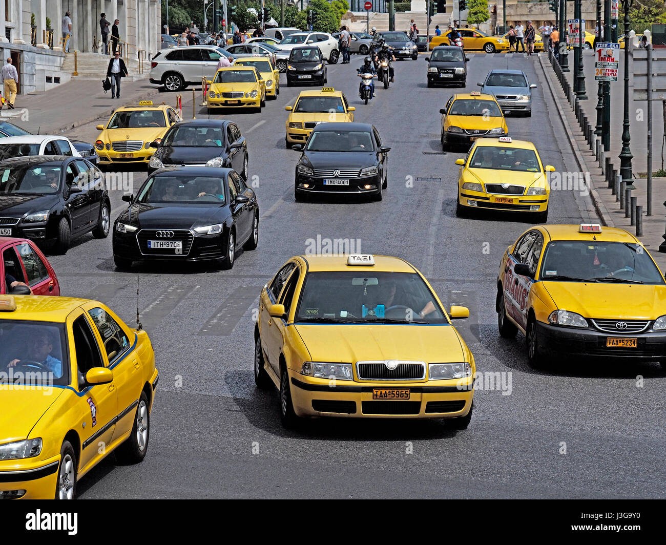 Traffic in Athens with numerous taxis Stock Photo - Alamy
