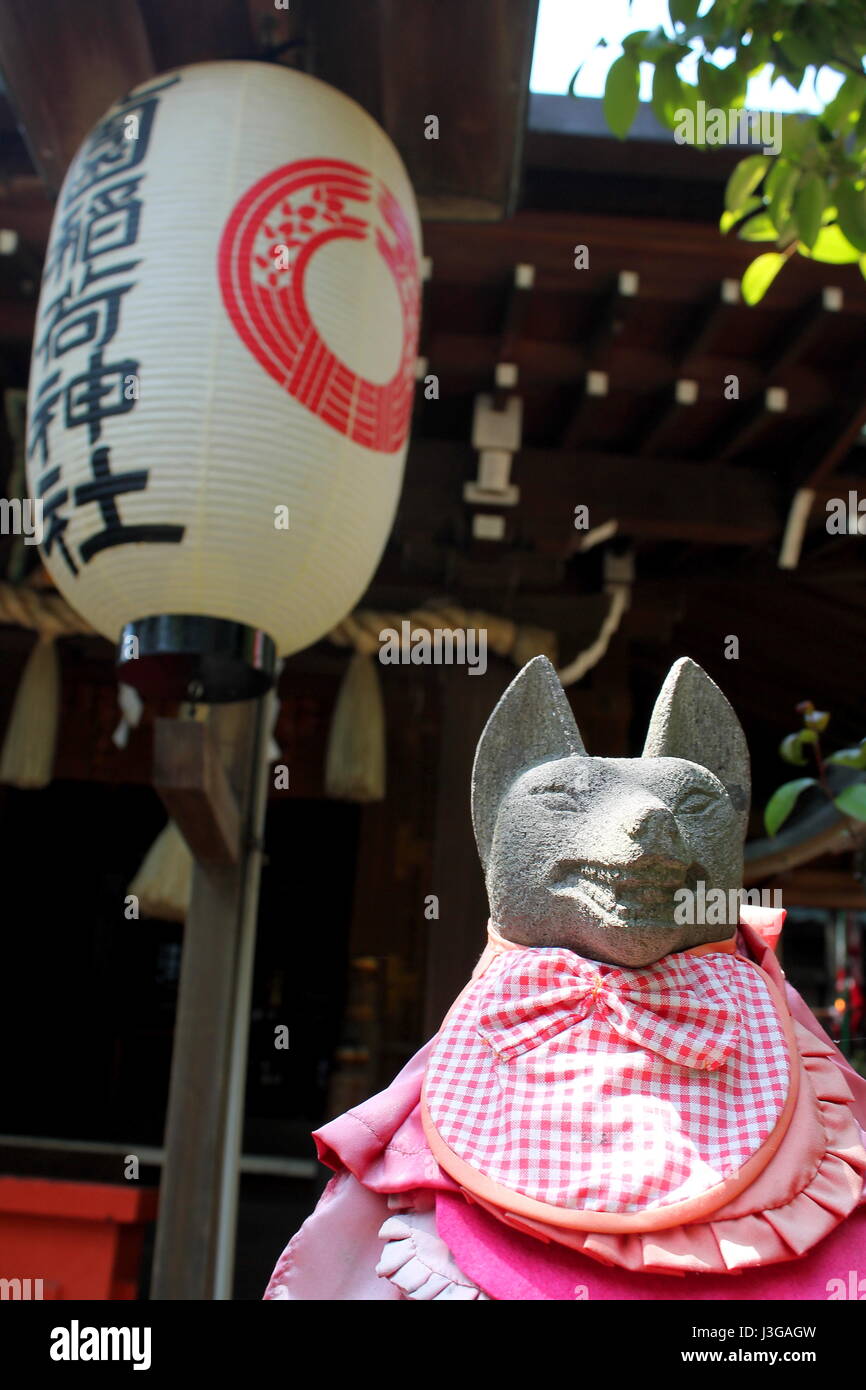A popular Inari (fox) statue as a part of the Shinto temple complex in ...