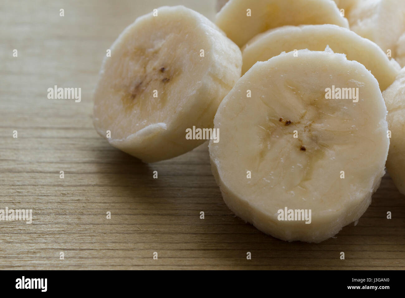 Sliced bananas on a wood cutting board Stock Photo - Alamy
