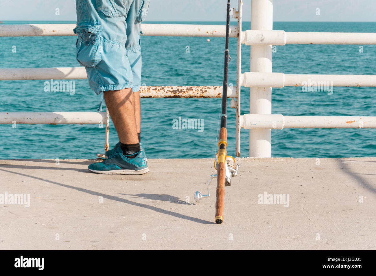 A Man Putting His Fishing Rod on the Ground and Waiting for fishes ...