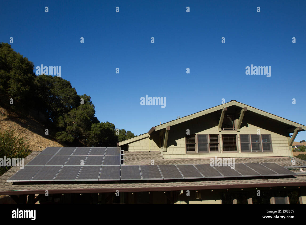solar panels on roof of house. horizontal orientation, blue sky, gray ...