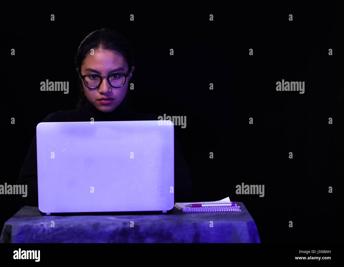 Portrait of hacker with laptop on dark background Stock Photo - Alamy