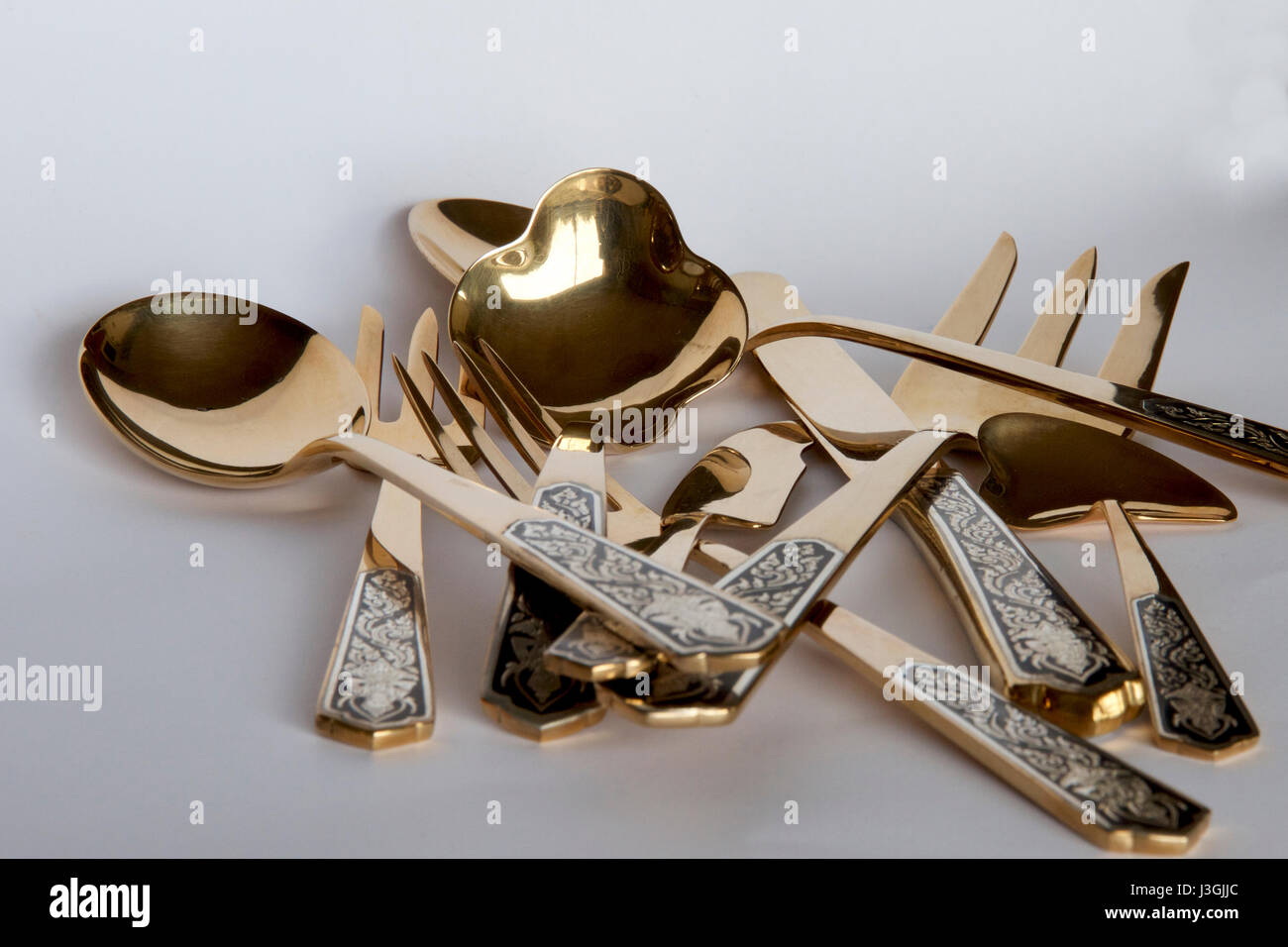 Thai gold knives, forks and spoons Stock Photo - Alamy