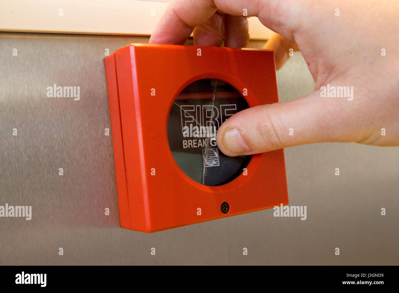 A fire alarm being pushed and activated Stock Photo - Alamy