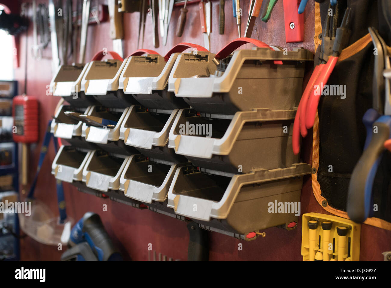 Variety boxes on wall of garage Stock Photo - Alamy