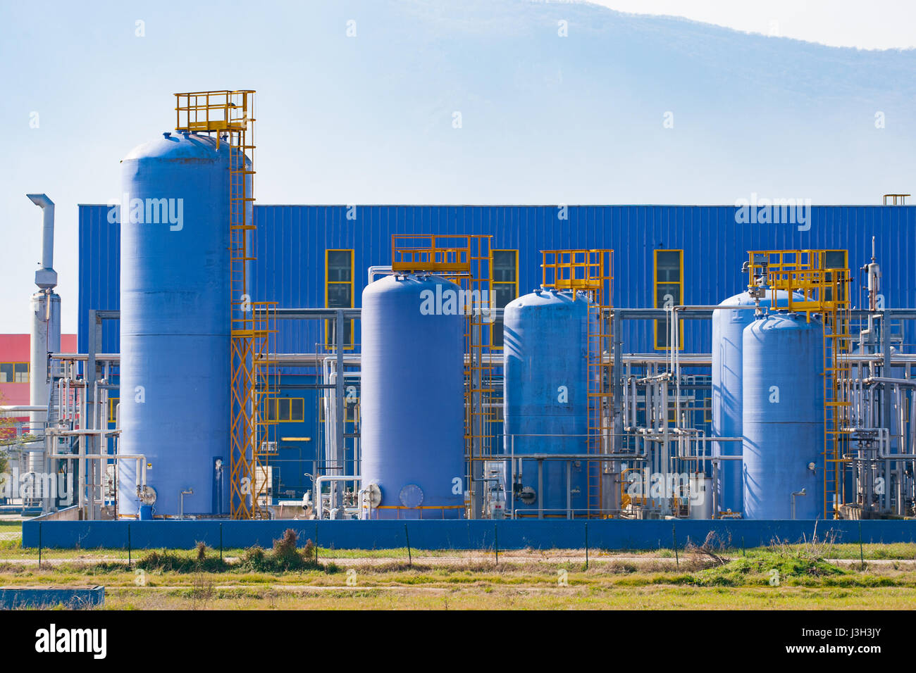 Industrial silos of a modern factory, everything is painted blue Stock ...