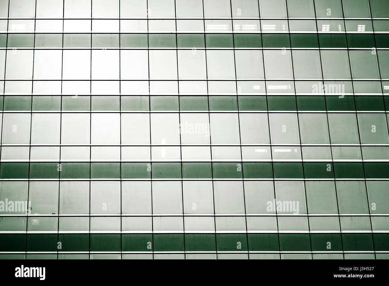 Modern office building detail, glass surface with green color Stock ...