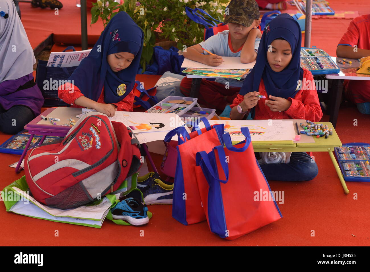 Girls drawing artwork, Malacca, Malaysia Stock Photo - Alamy