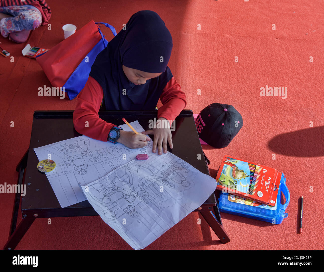 Girl showing off her drawing talents, Malacca, Malaysia Stock Photo - Alamy