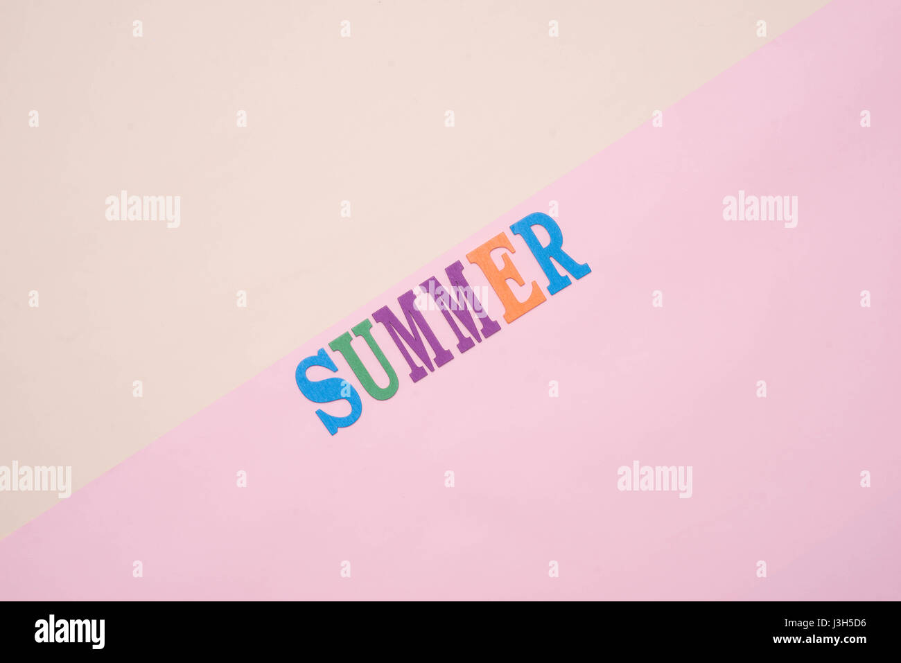 Summer fun written in colorful wooden letters on pastel color ...