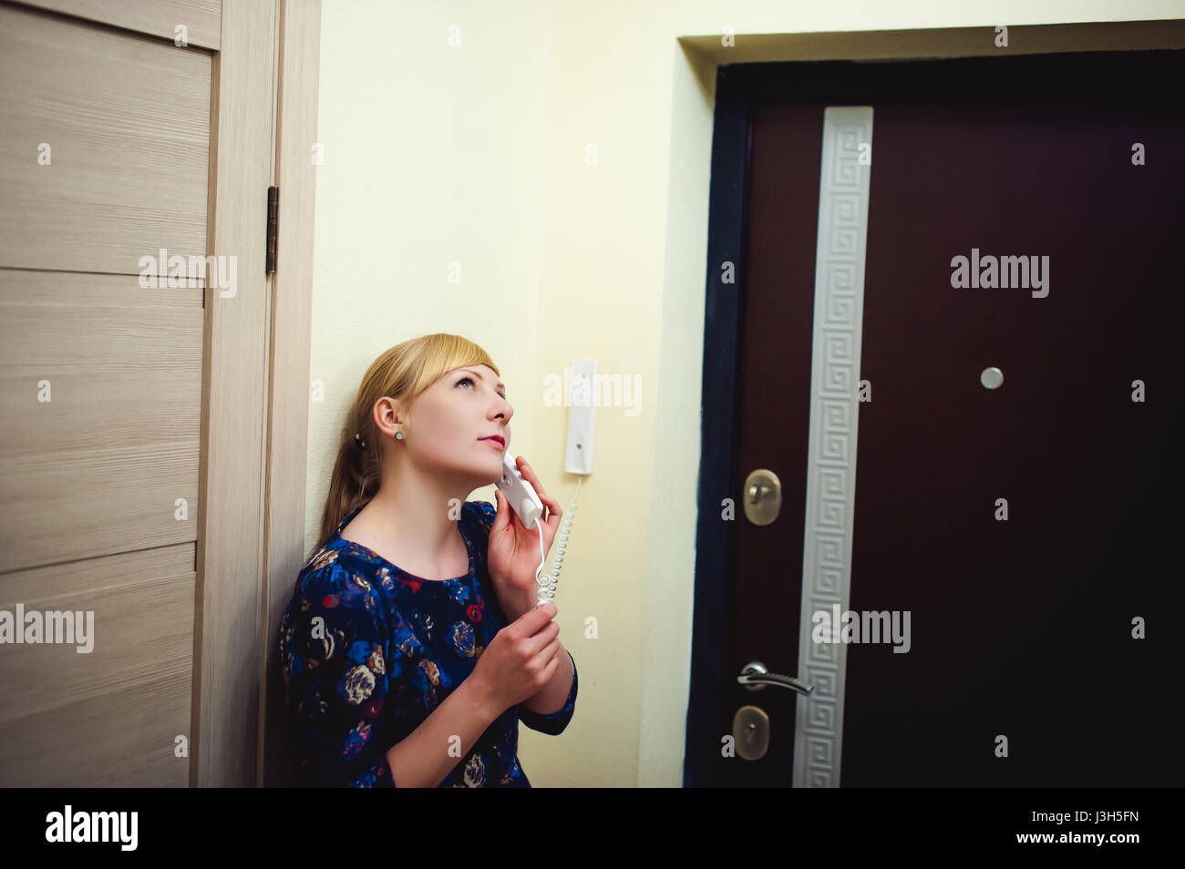 Woman answers door hi-res stock photography and images - Alamy