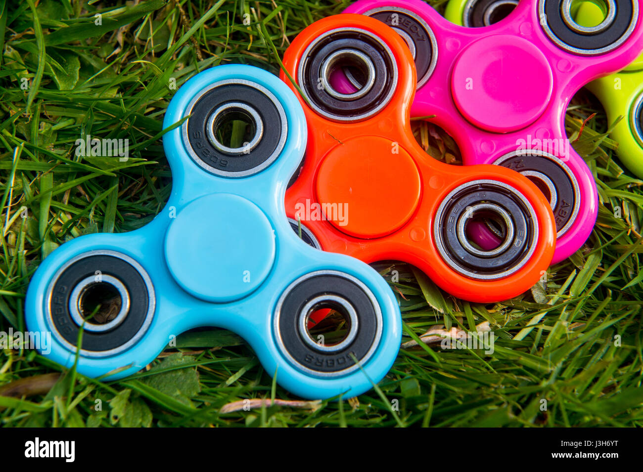 Blue, Orange and pink fidget spinners Stock Photo - Alamy