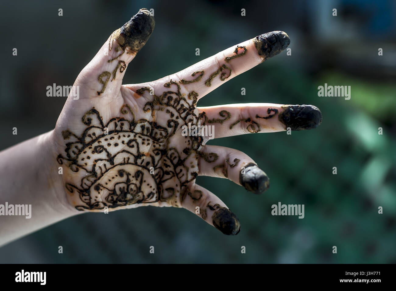 A girl showing his hand decorated with ;Hanna' Stock Photo - Alamy