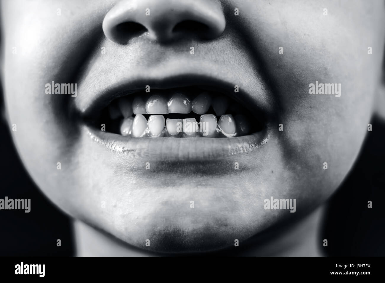 A boy showing his teeth Stock Photo - Alamy