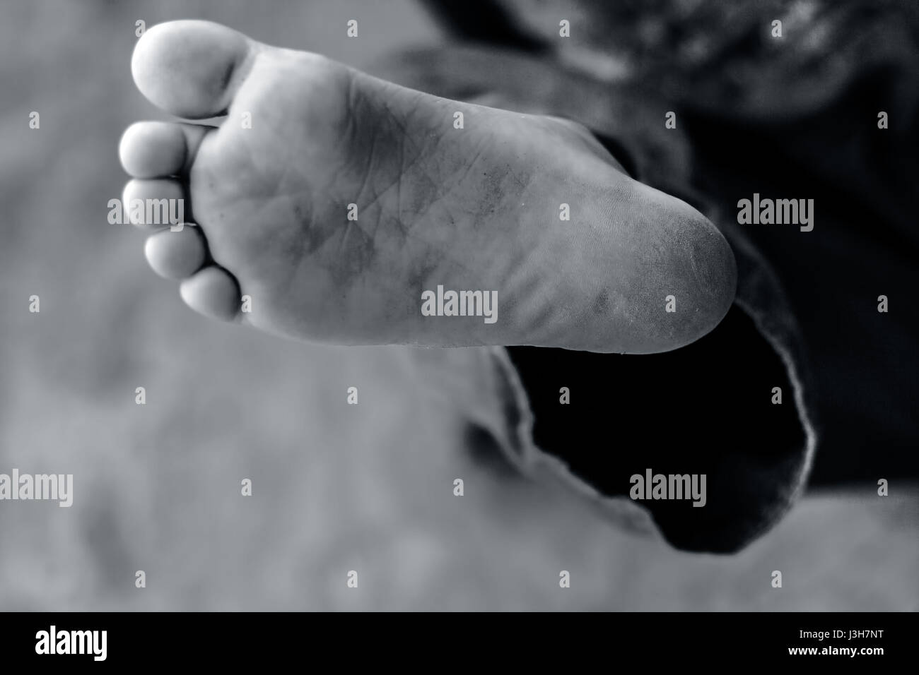 A boy showing his dirty foot Stock Photo - Alamy