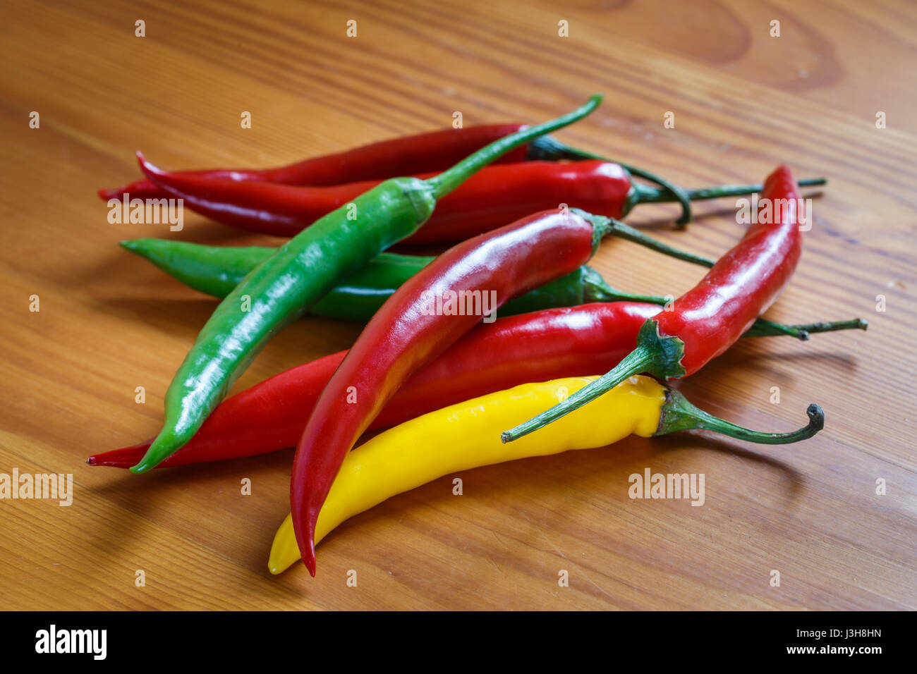 Hot chili peppers. Chilli pepper on the wooden background Stock Photo ...