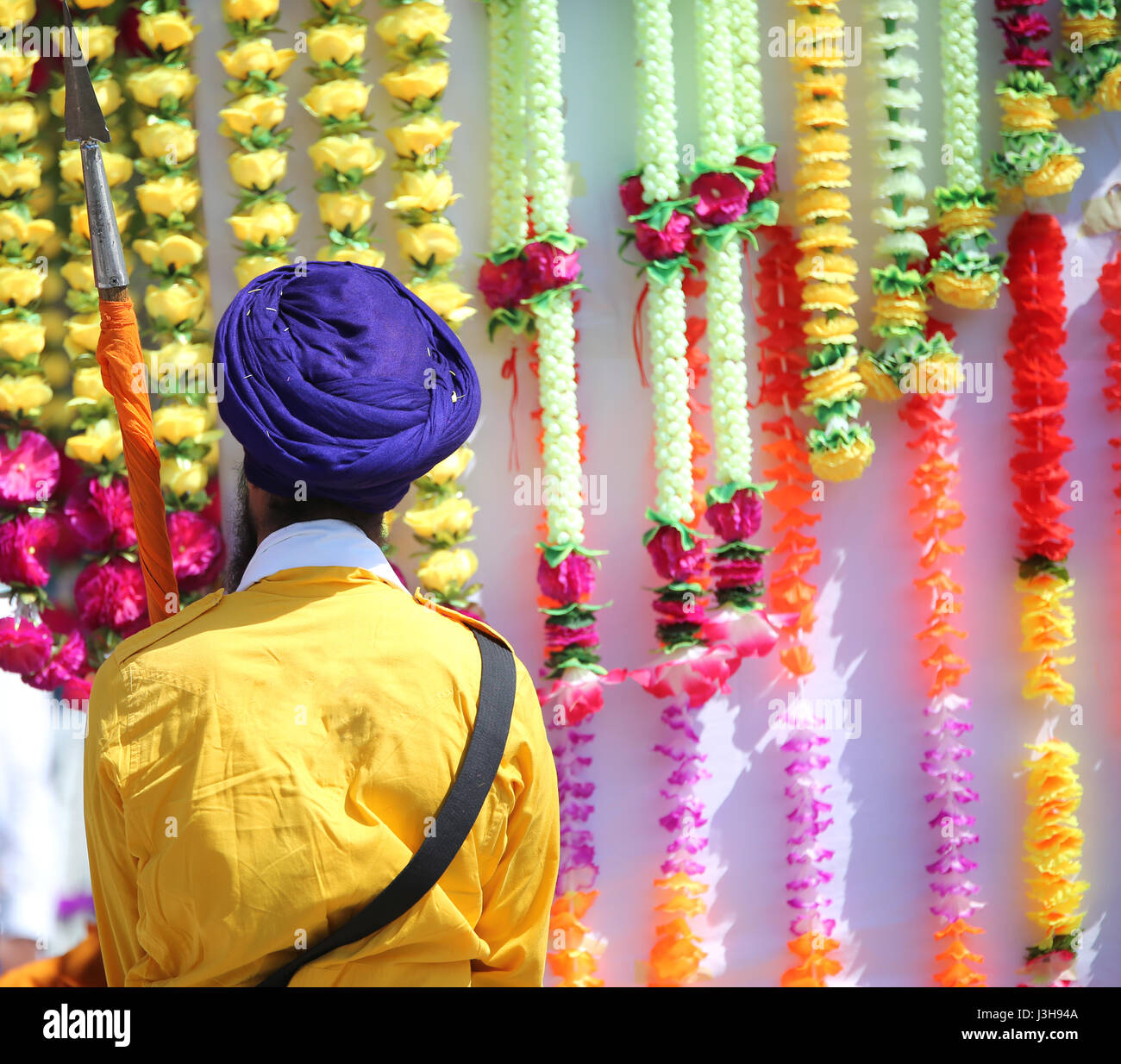 sikh man during an event with many chains of flowers Stock Photo - Alamy