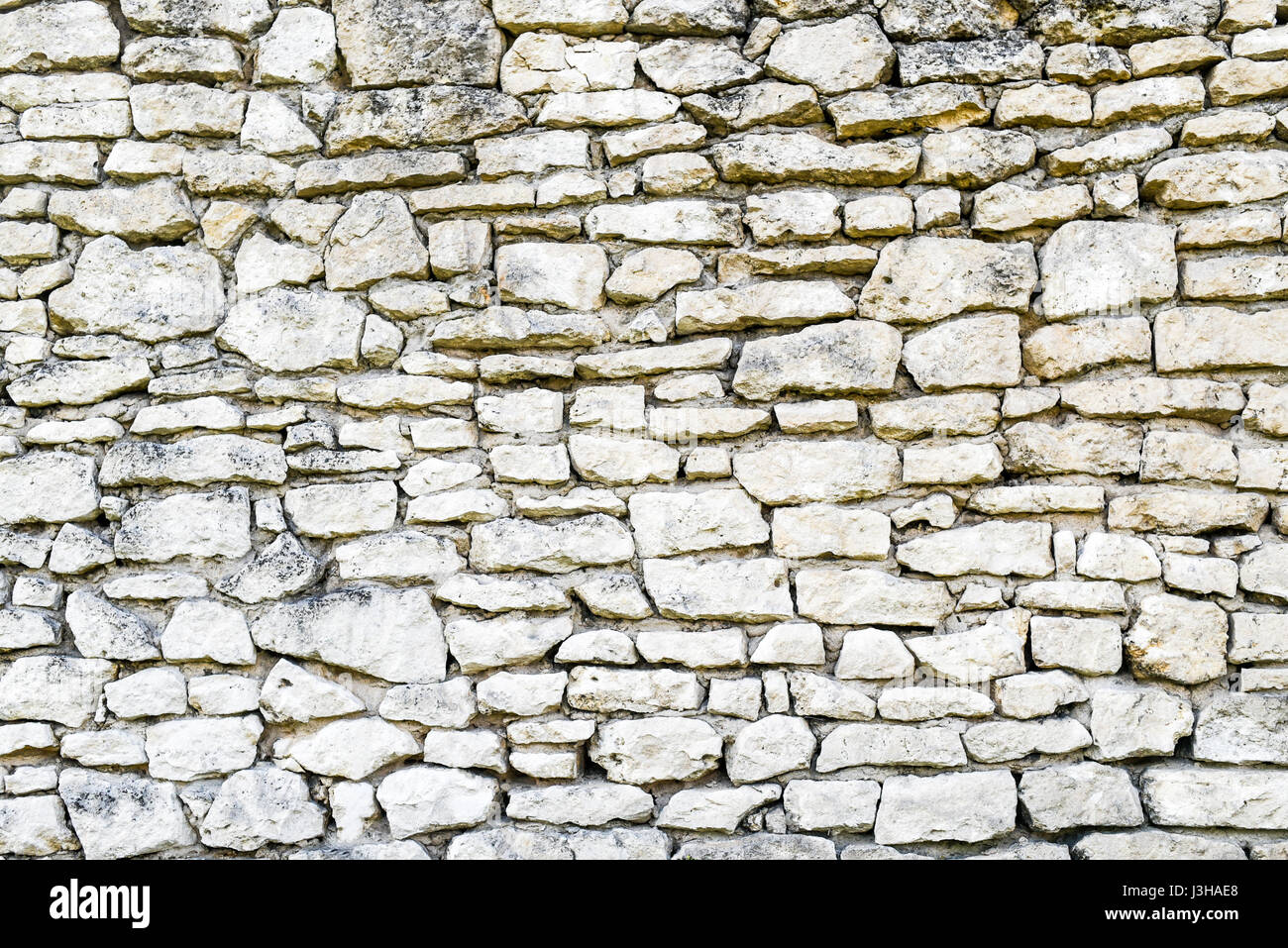White irregular brick wall texture or background Stock Photo - Alamy