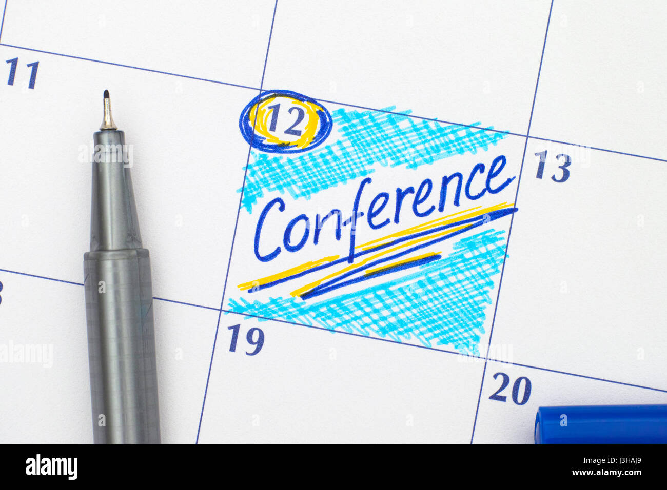 Reminder Conference in calendar with blue pen Stock Photo - Alamy