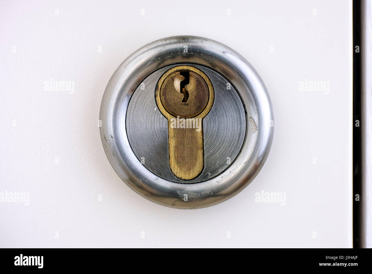 Close-up of keyhole in white door Stock Photo - Alamy