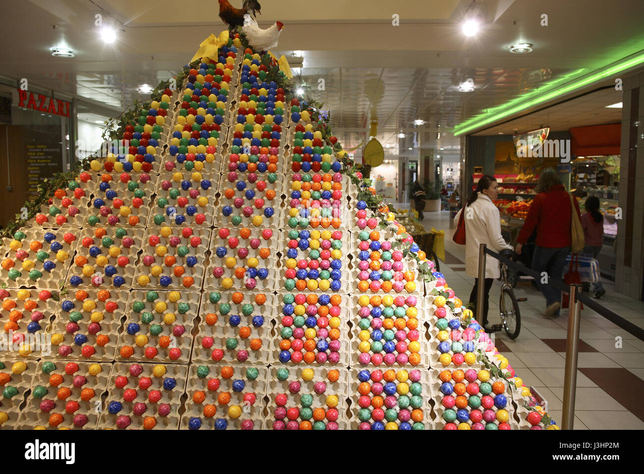 Germany, Cologne, pyramid with colored Easter eggs in a shopping mall ...