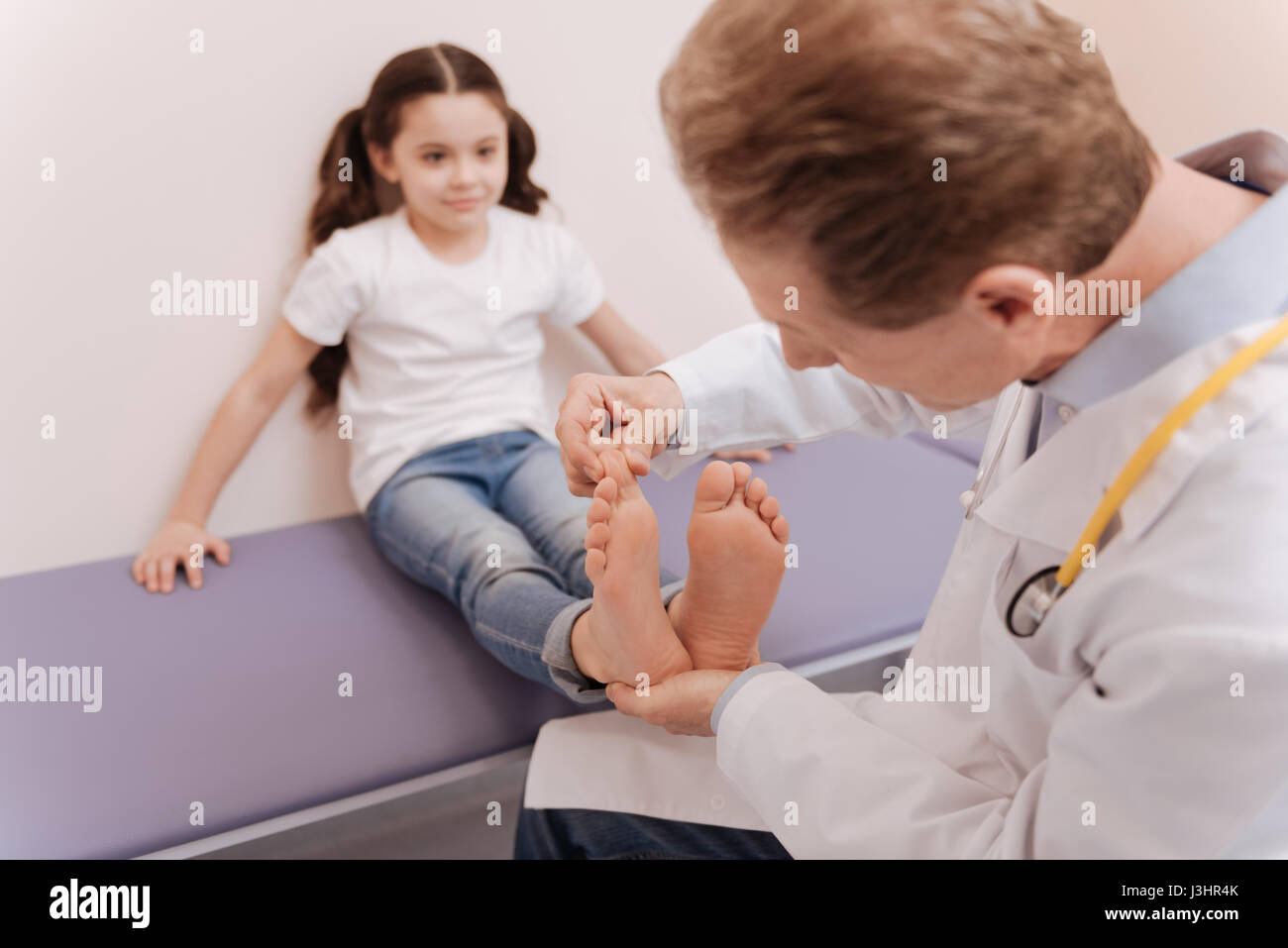 Try to move it. Regular competent local rheumatologist conducting a ...