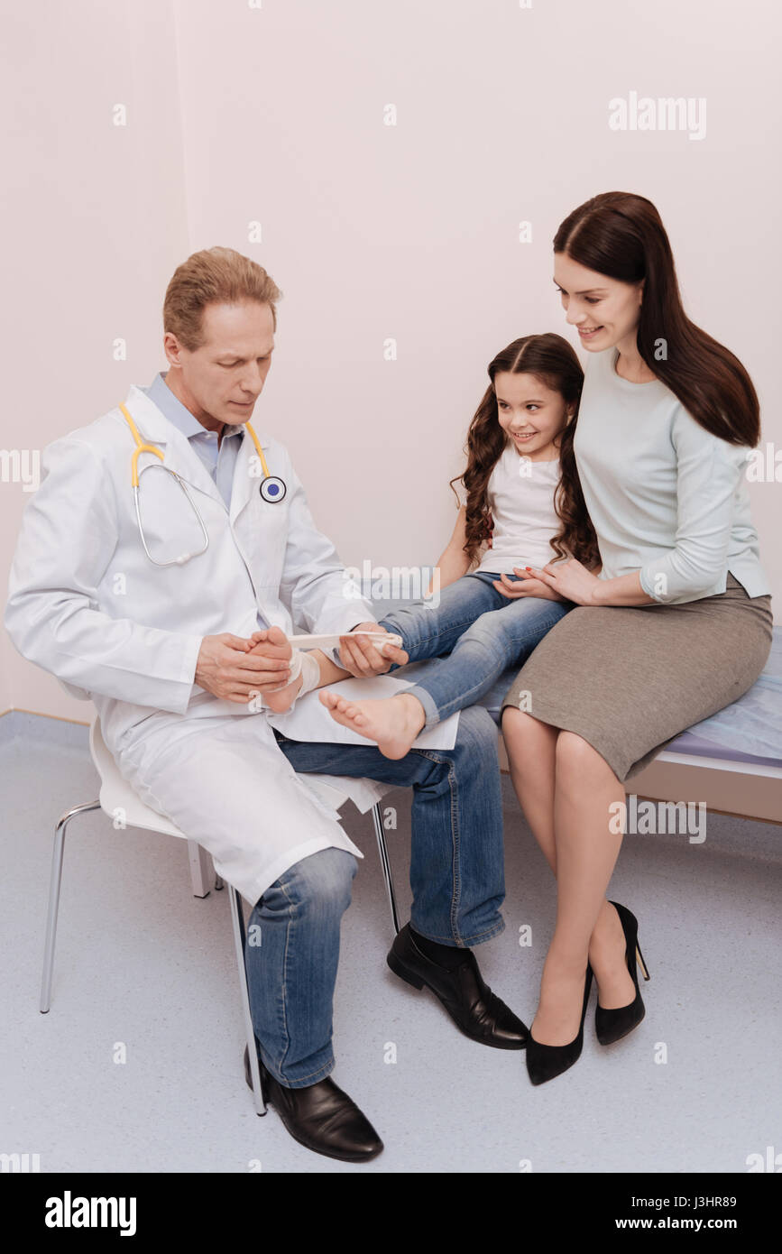 Emergency issue. Adorable restless little girl damaging her ankle and ...