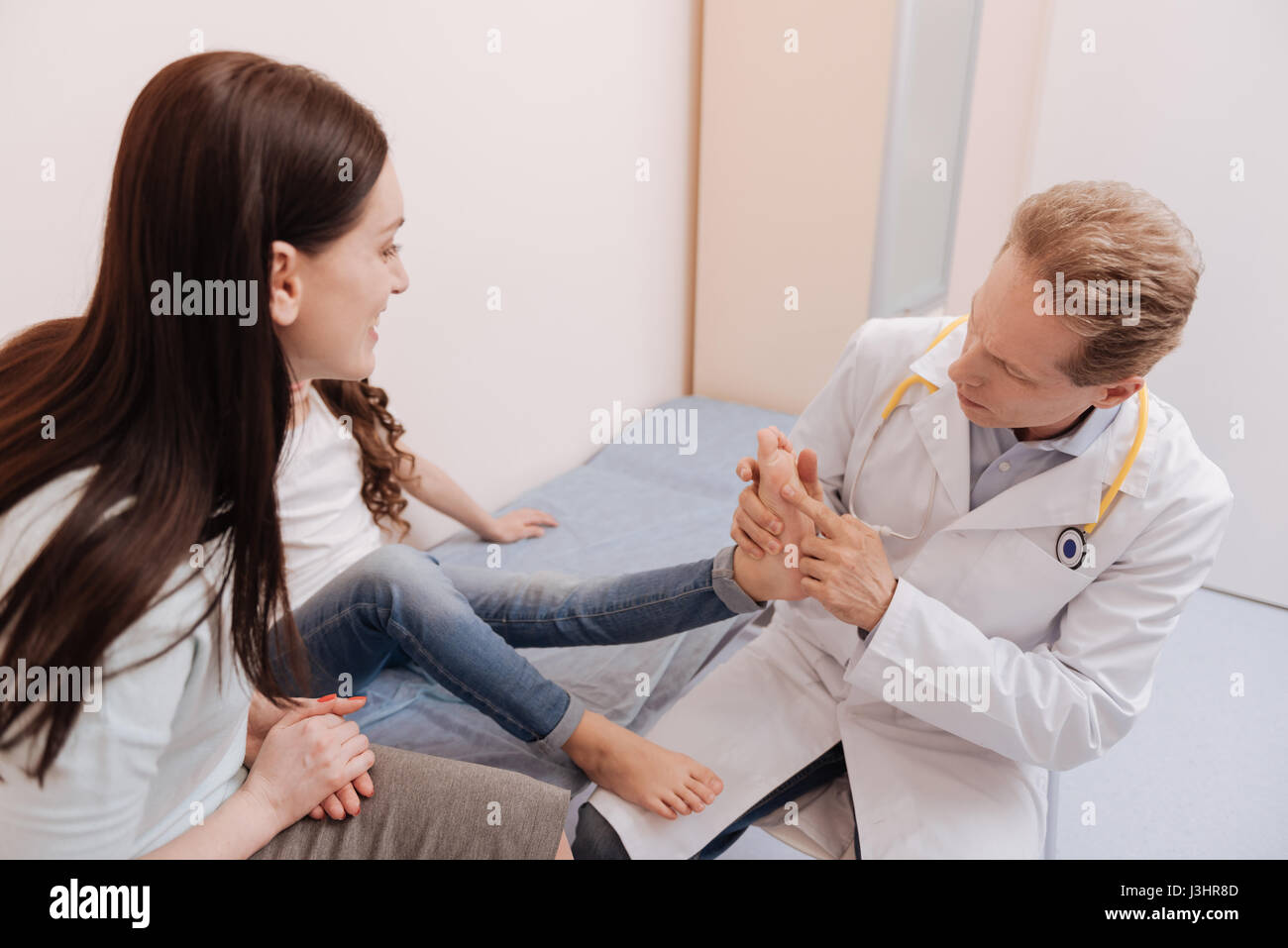 Best specialist in town. Sweet concerned young lady sitting at doctors ...