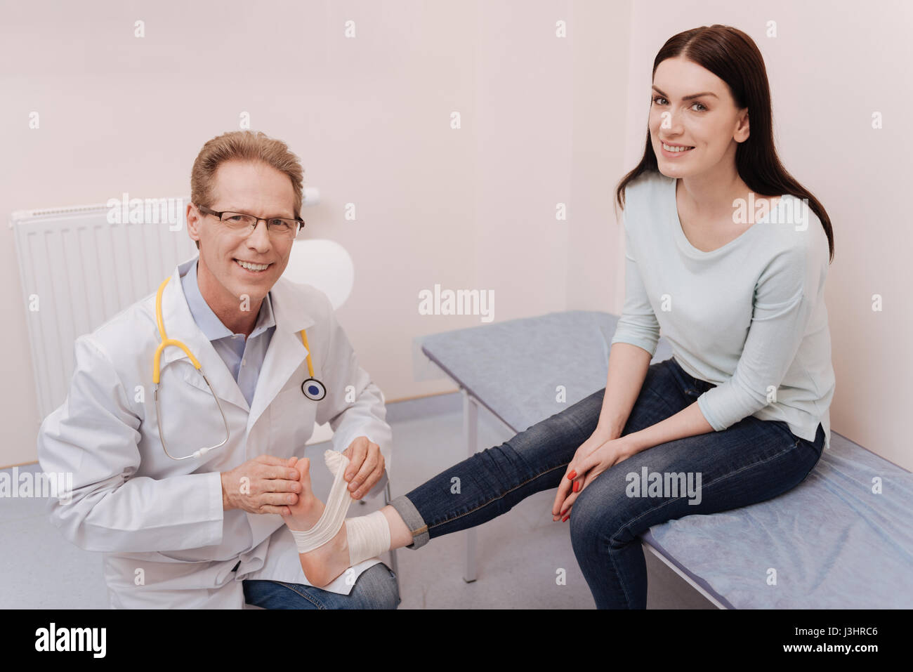 Ready to help anyone. Charismatic positive distinguished doctor using ...