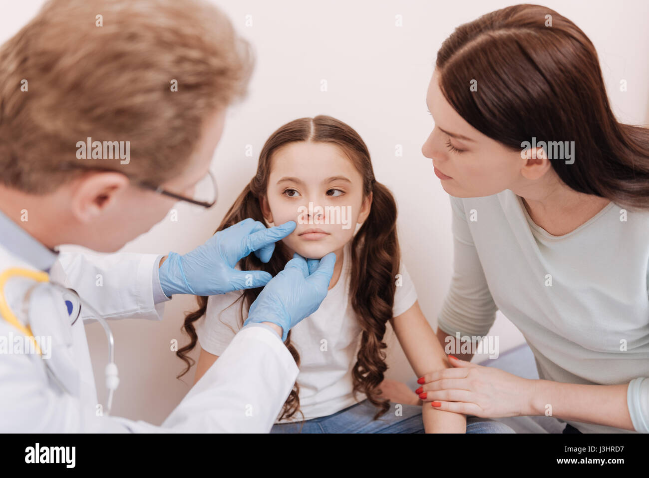 Unusual hives. Tender concerned loving mother paying specialist a visit ...