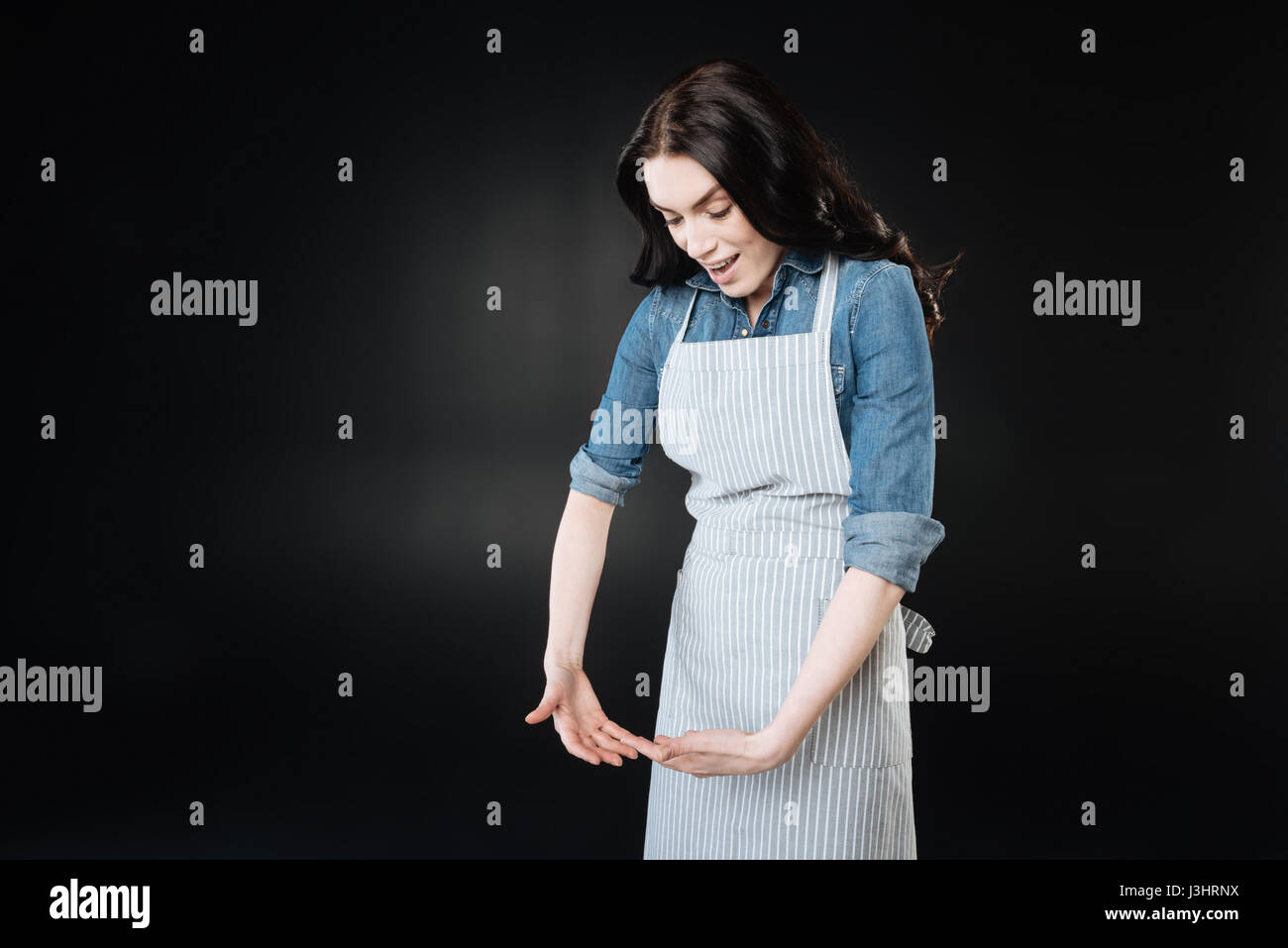 I got something. Young cute female bowing her head holding hands ...