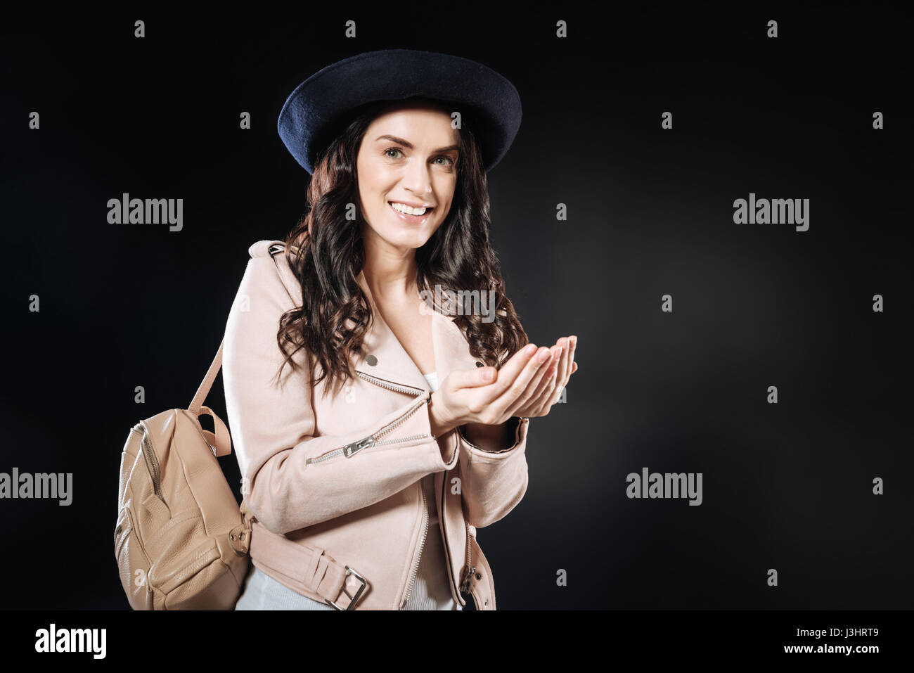 Tenderness mood. Attractive smiling brunette keeping backpack on the ...