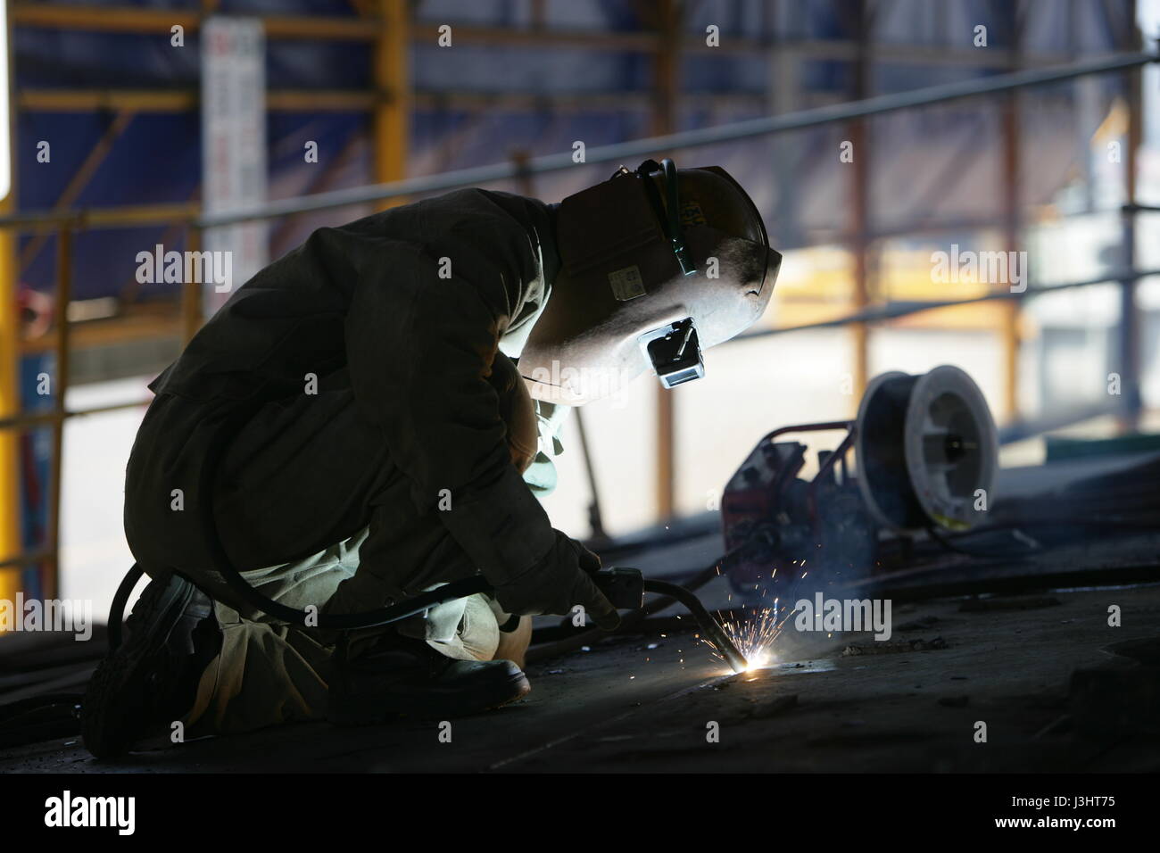 A worker welding in a ship yard Stock Photo - Alamy