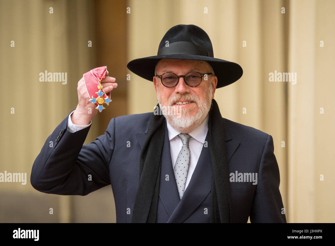 Cartoonist Peter Brooks with his CBE medal, awarded by Queen Elizabeth ...