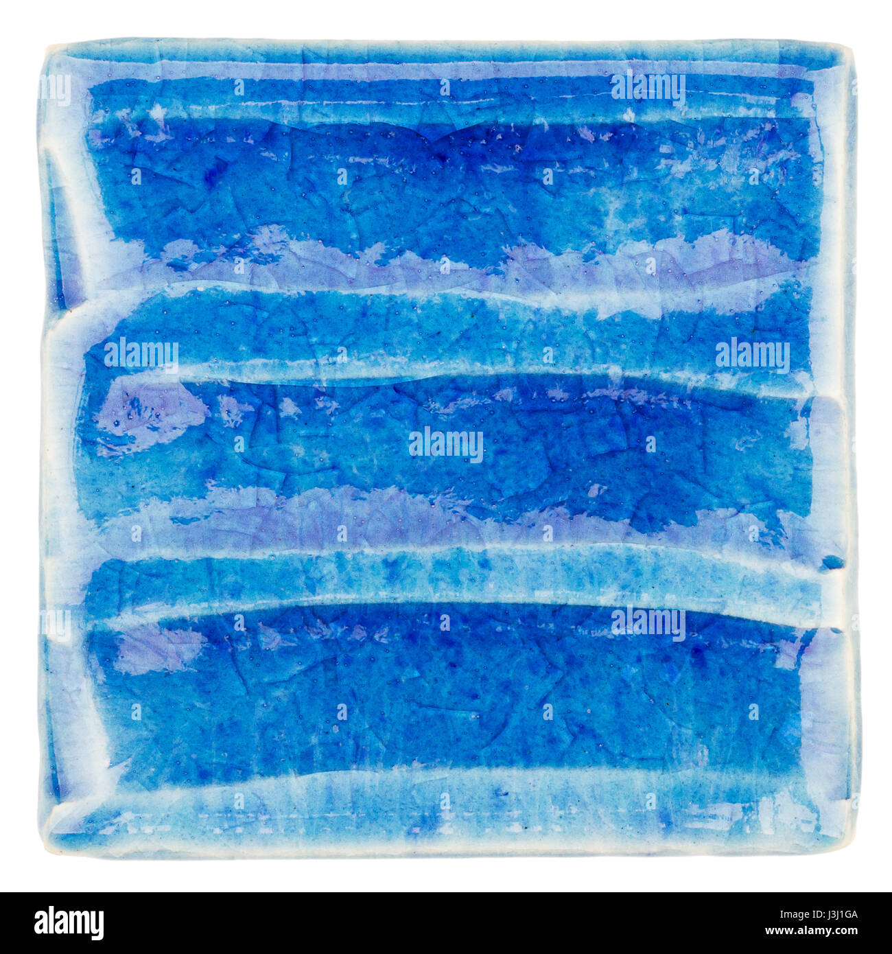 Blue lined handmade glazed ceramic tile isolated on white background ...
